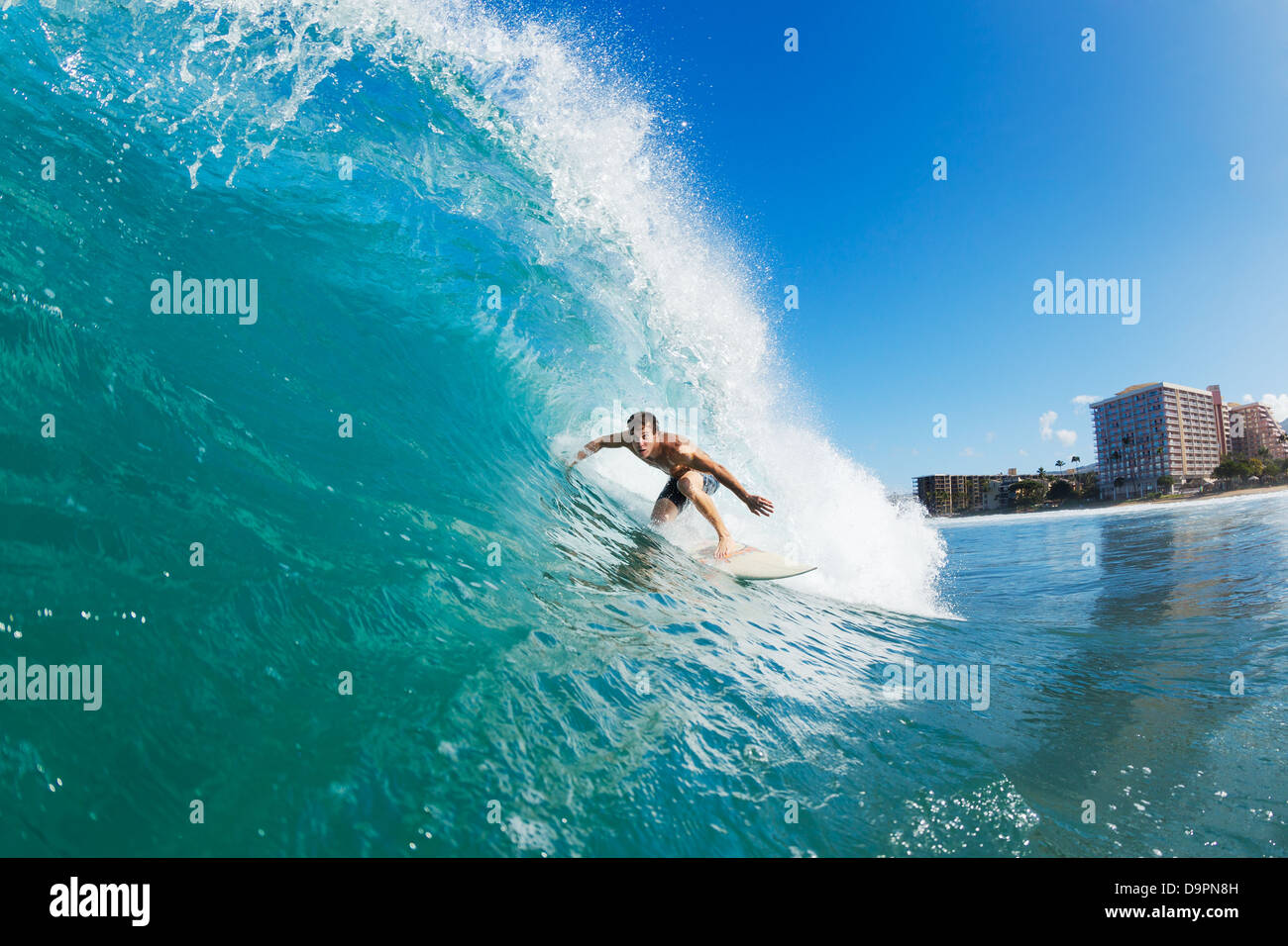 Surfer on Blue Ocean Wave Getting Barreled Stock Photo - Alamy
