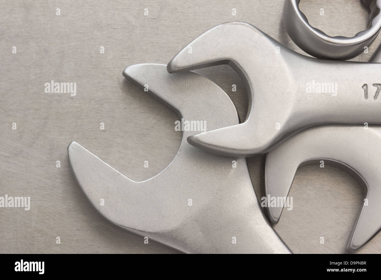 wrench tool at metal background Stock Photo - Alamy