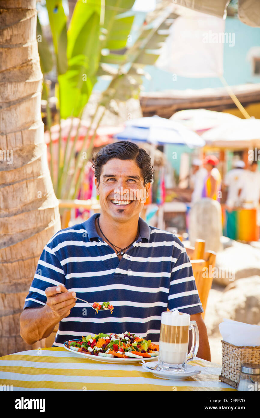 Man eating at outdoor café Stock Photo - Alamy