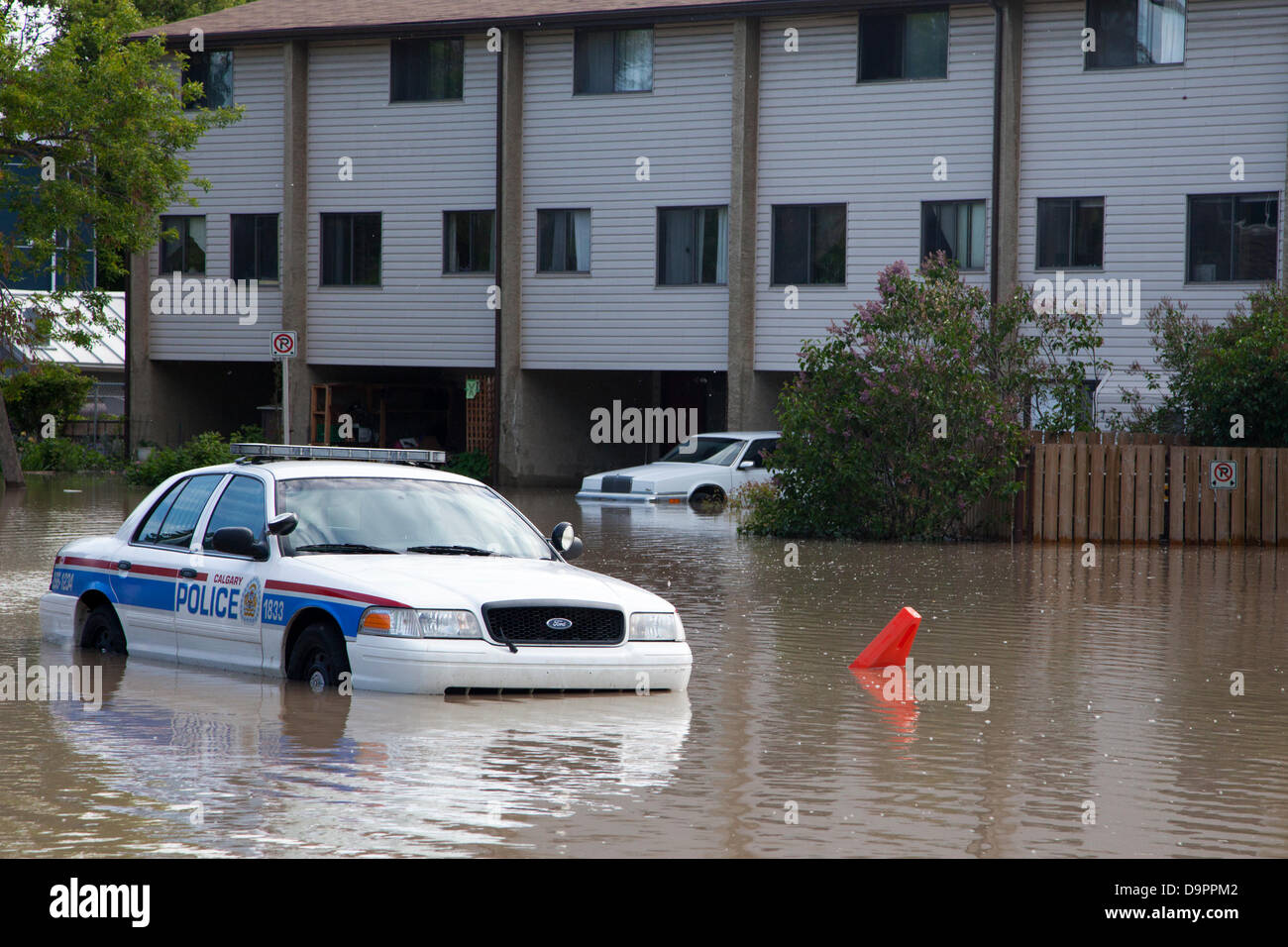 A police car trapped by rapidly rising floodwaters as police went door ...