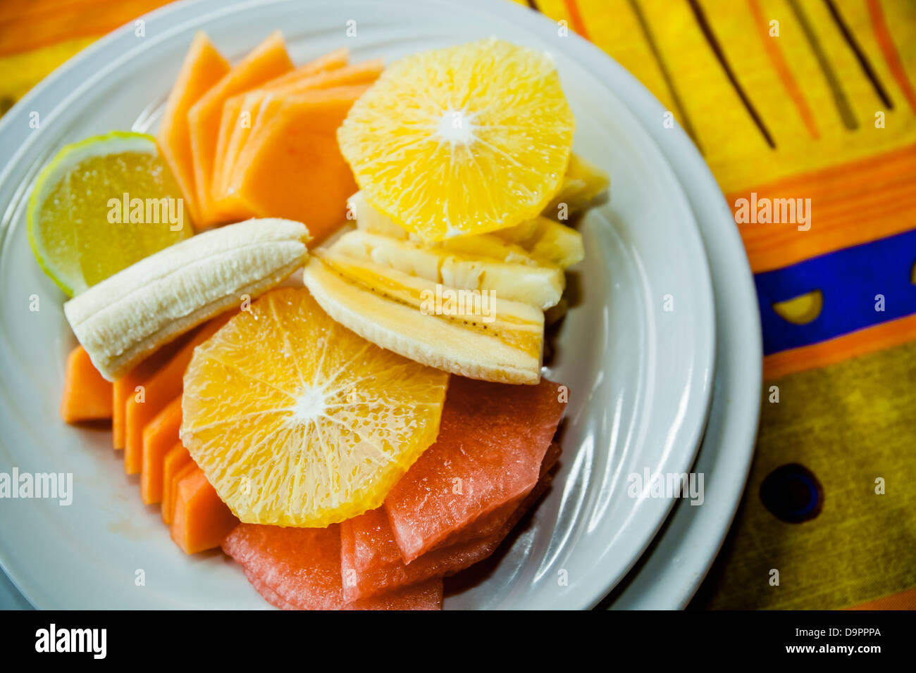 Place setting with plate of fruit Stock Photo - Alamy