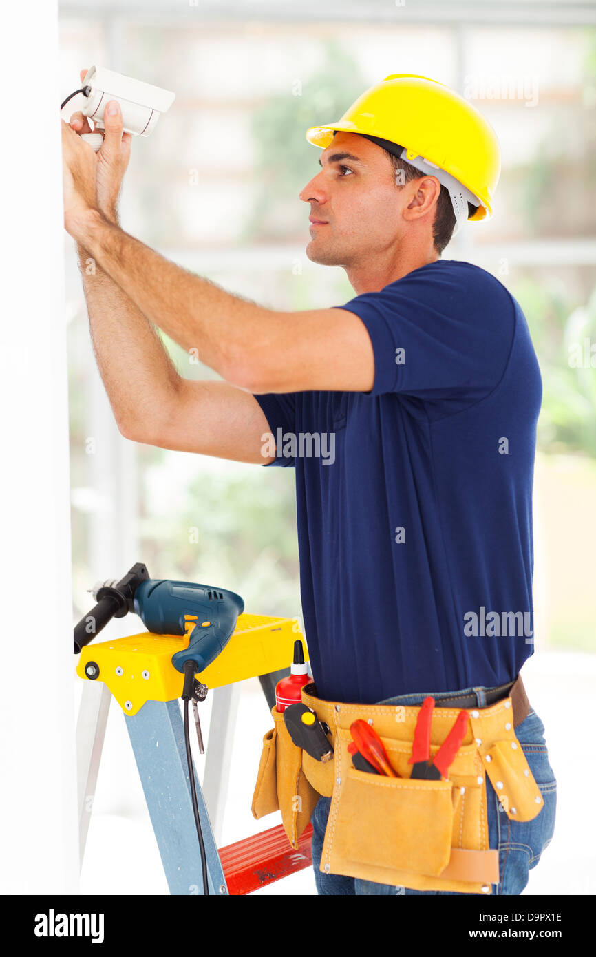 Security surveillance technician adjusting cctv hi-res stock ...