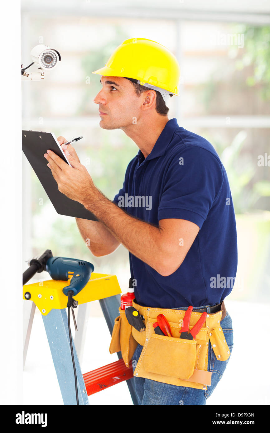 professional cctv technician recording camera serial number Stock Photo ...