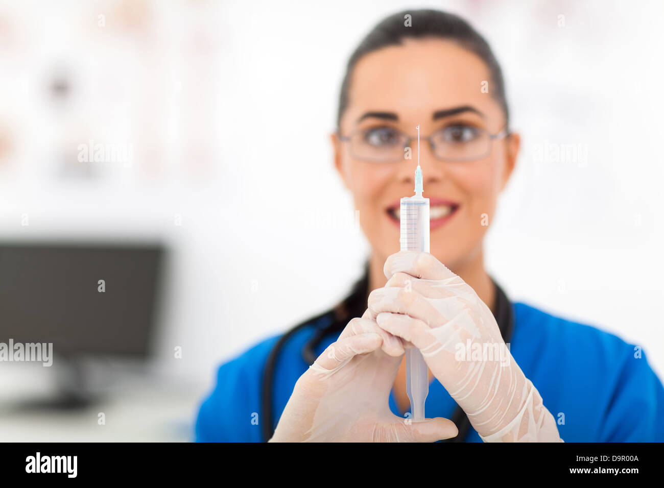 happy veterinarian holding syringe with needle and preparing for ...