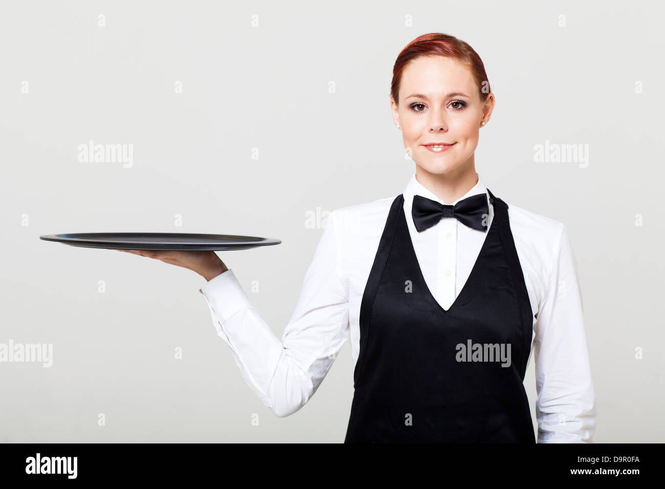 pretty waitress with an empty tray Stock Photo - Alamy