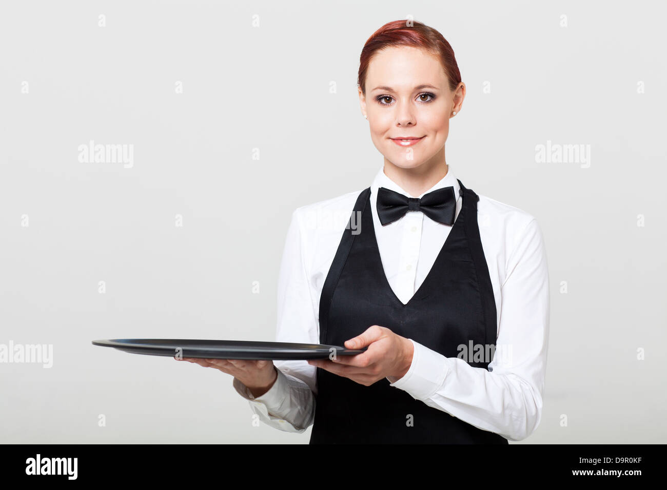 pretty waitress holding an empty tray Stock Photo - Alamy