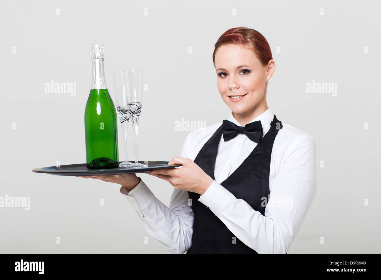 pretty waitress holding a tray with champagne and glass Stock Photo - Alamy