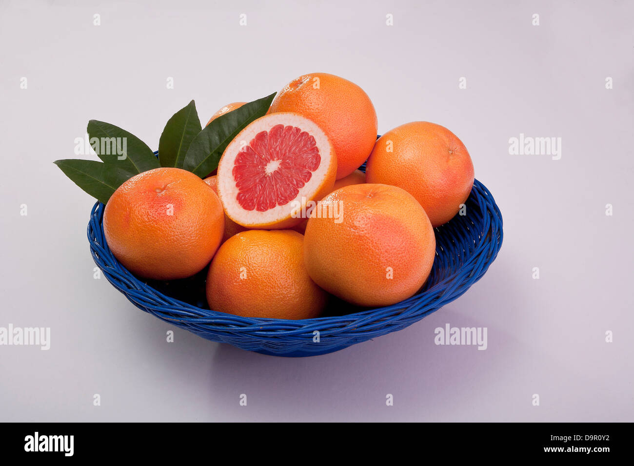 group of fresh ruby red grapefruits cut and whole Stock Photo - Alamy
