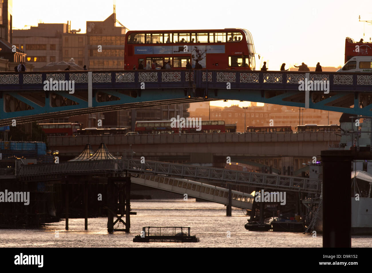 Buses driving across bridges on The River Thames in Central London in ...