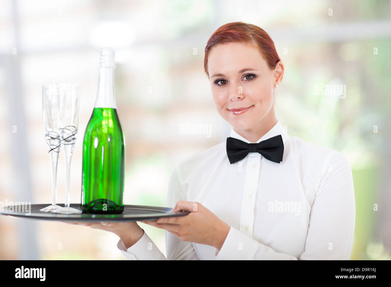 pretty young waitress serving champagne in restaurant Stock Photo - Alamy