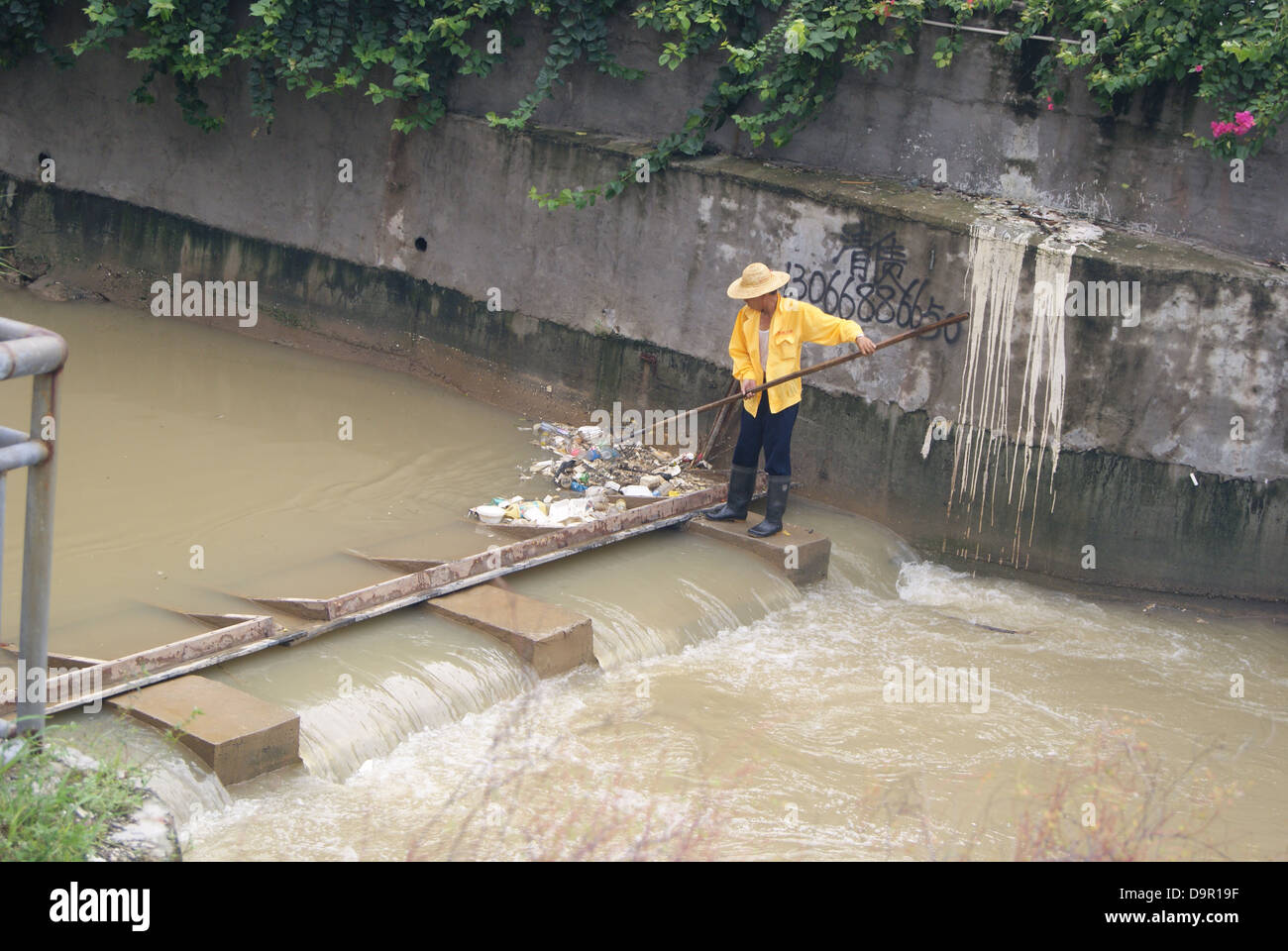 A worker in dredging river in Shenzhen, China Stock Photo - Alamy