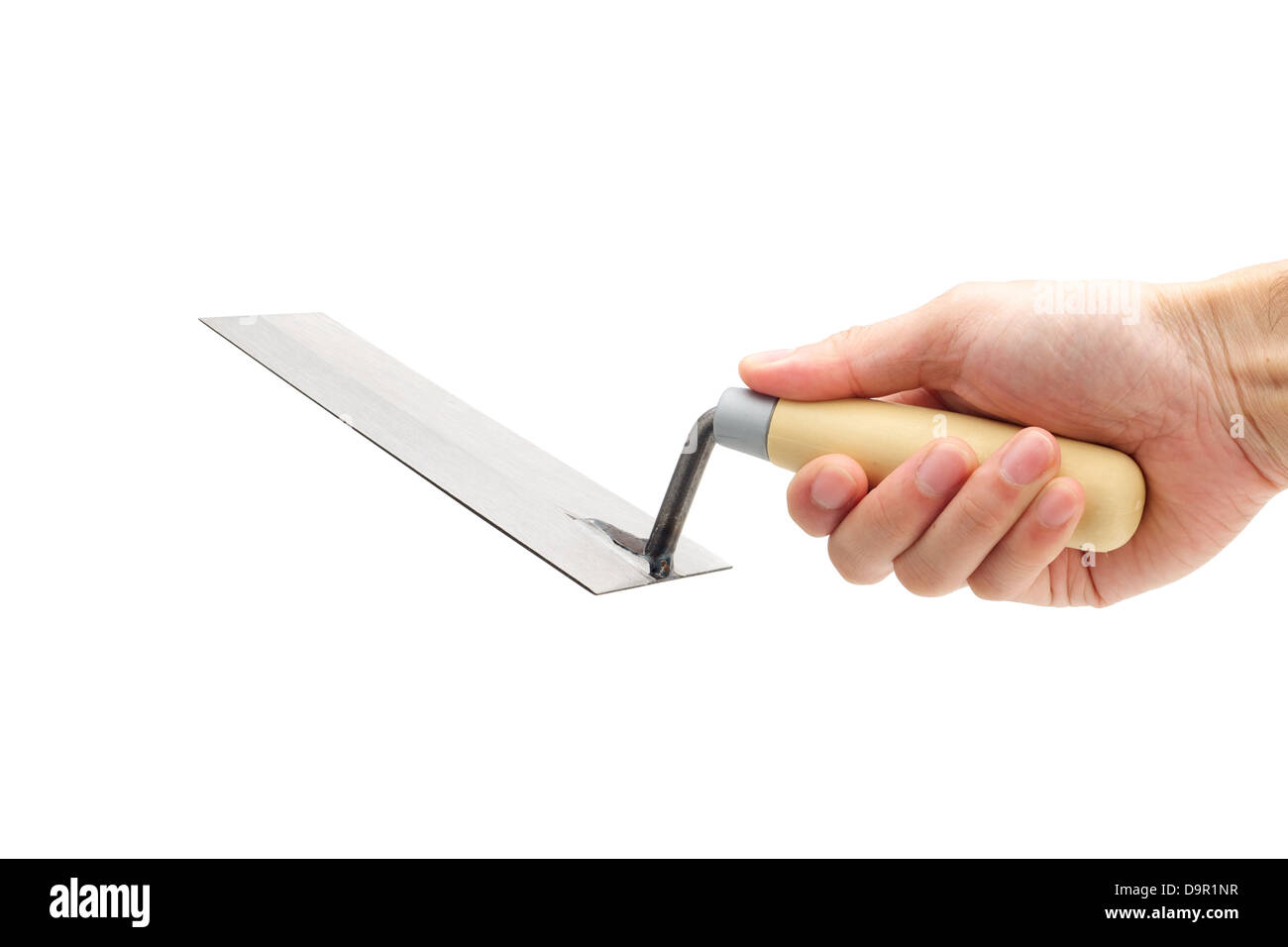 Hand holding trowel on white background Stock Photo - Alamy
