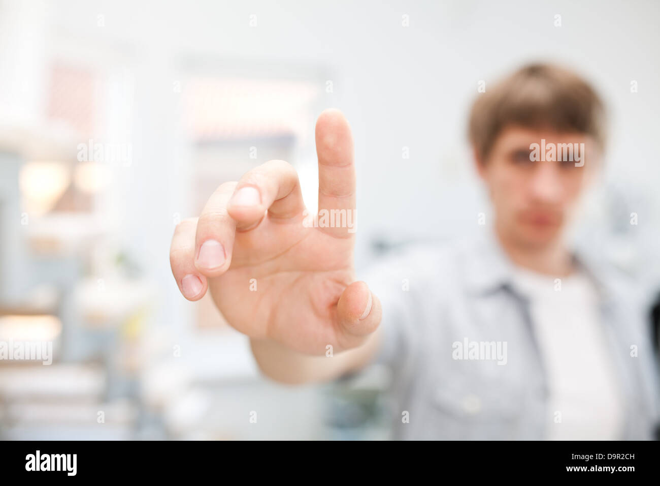 Young man working with virtual screen or pushing button Stock Photo - Alamy