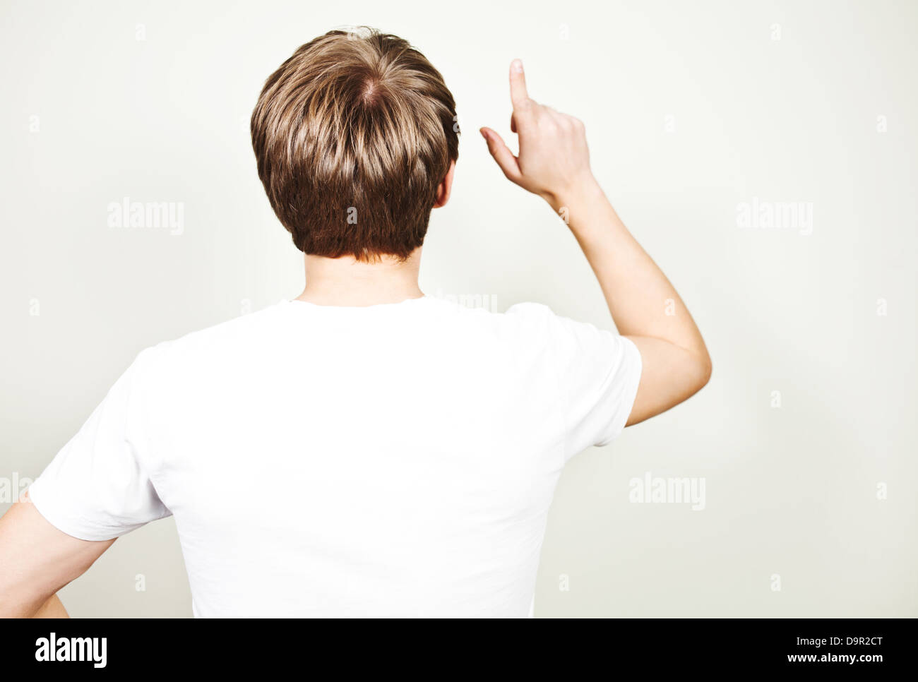 Back view of young man pointing up. Idea Stock Photo - Alamy