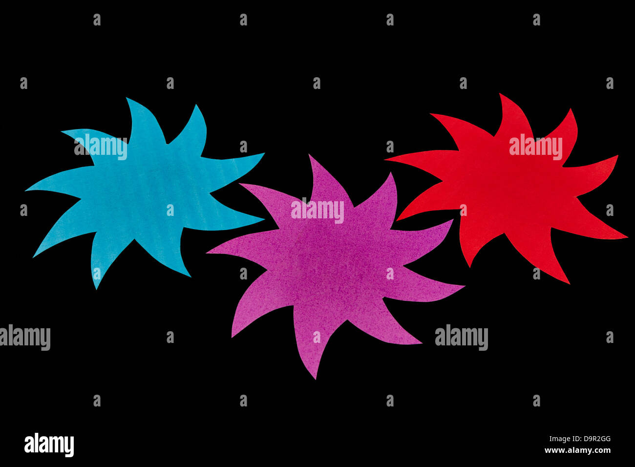 Coloured paper stars on black background Stock Photo - Alamy