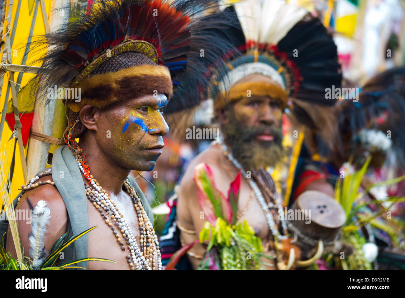Men dressed in traditional tribal outfits and wearing feather and ...