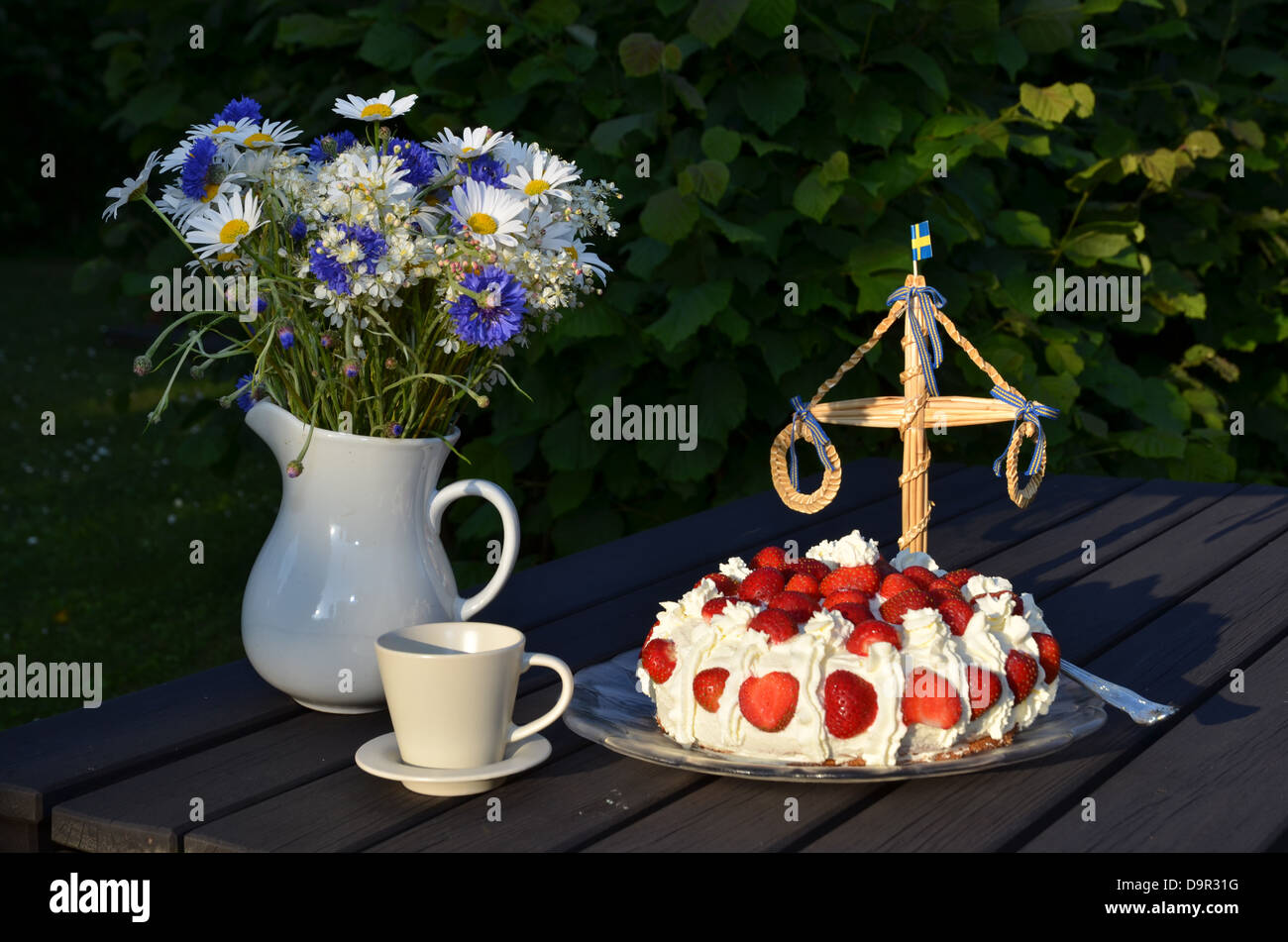 Table made for small midsummer coffee breake Stock Photo - Alamy