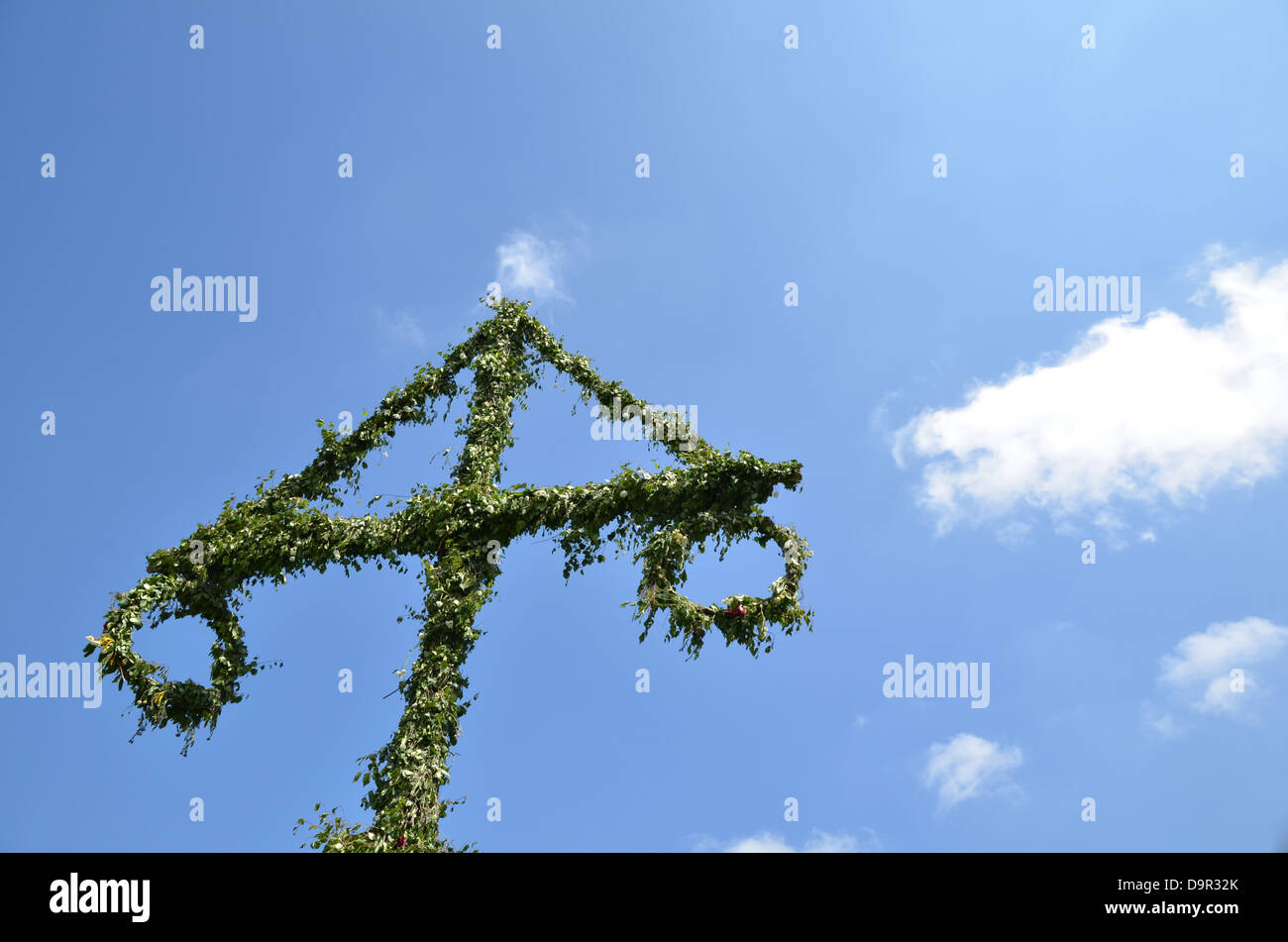 May pole , symbol for midsummer in Sweden, at a blue sky with white ...