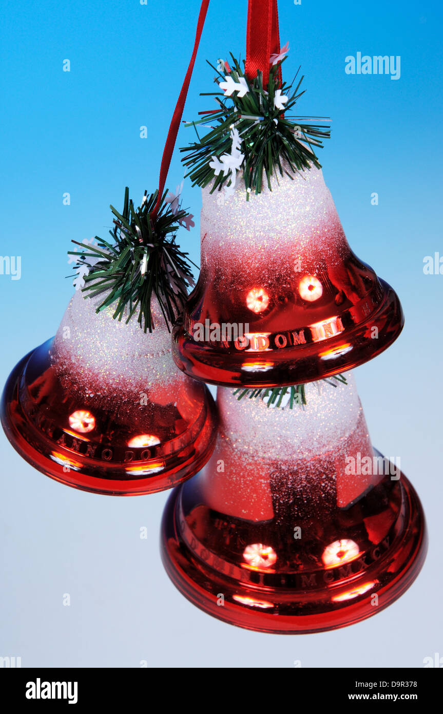 Red Christmas bells against a blue background Stock Photo - Alamy