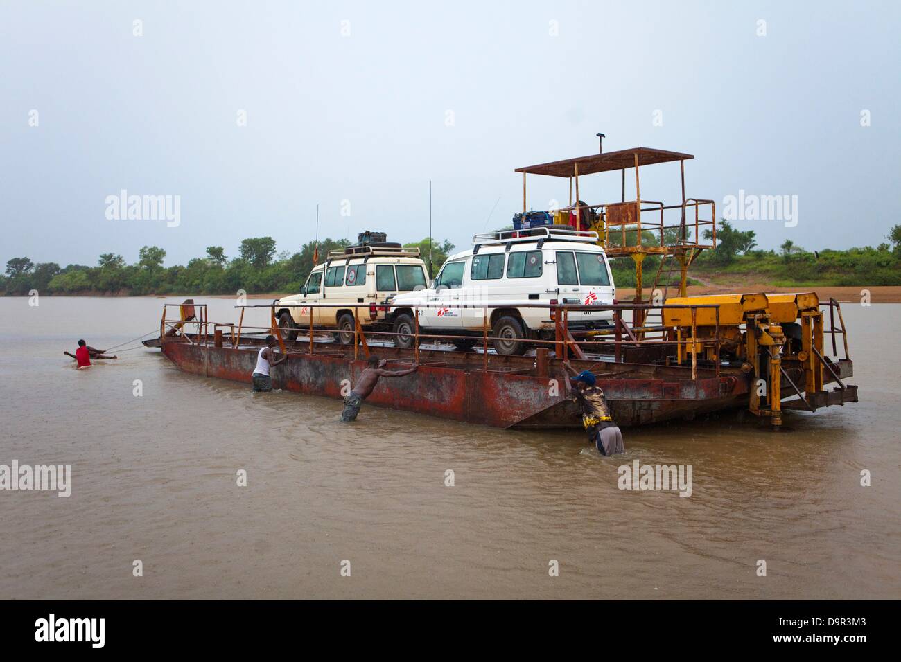 Cars of MSF crossing a river in central african republic Stock Photo ...