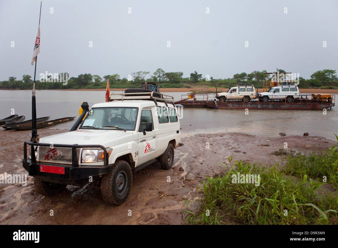Cars of MSF crossing a river in central african republic Stock Photo ...