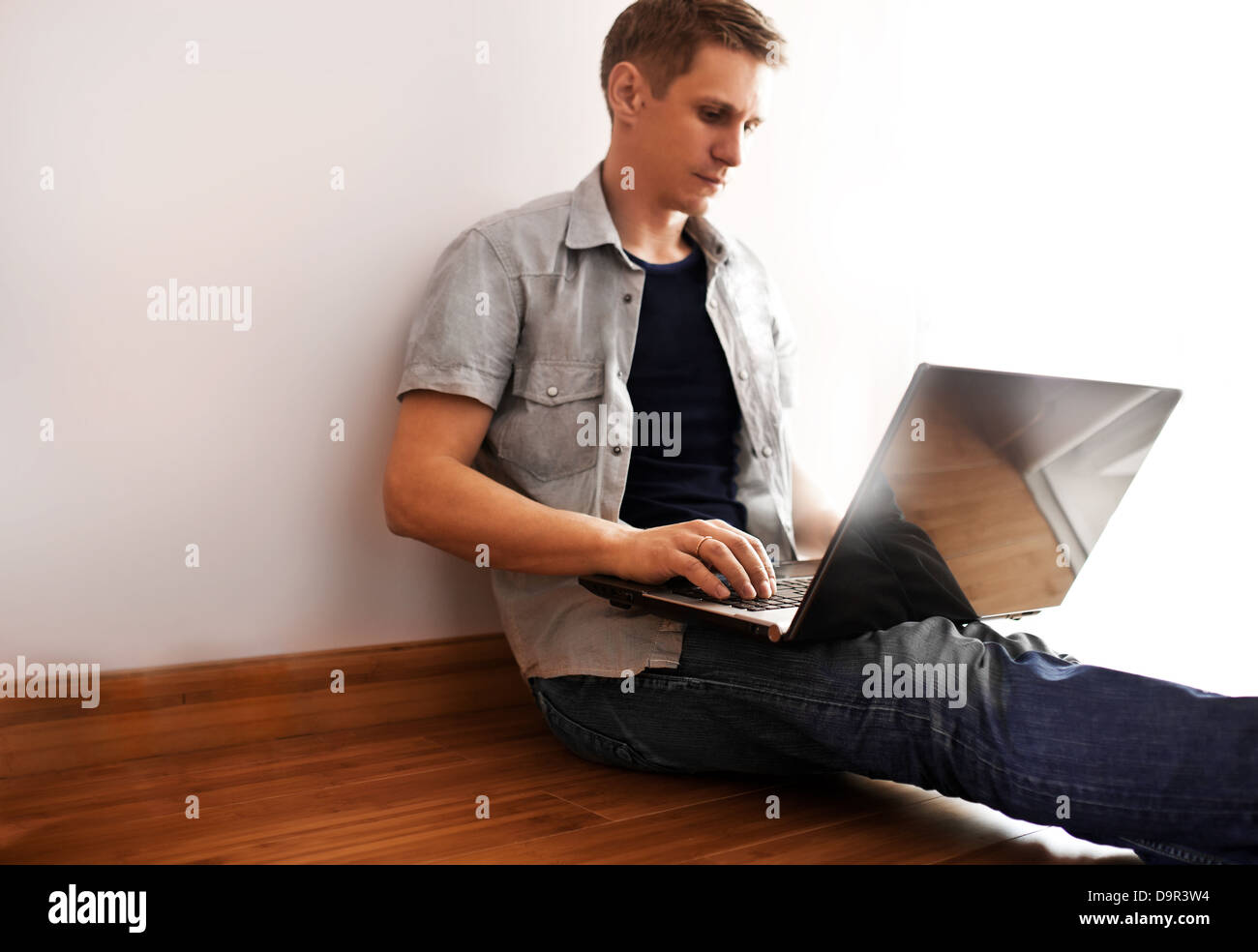 Man working on the laptop at home Stock Photo - Alamy
