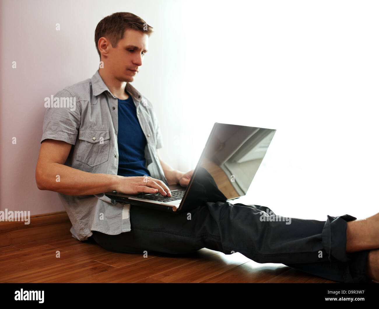 Man working on the laptop at home Stock Photo - Alamy