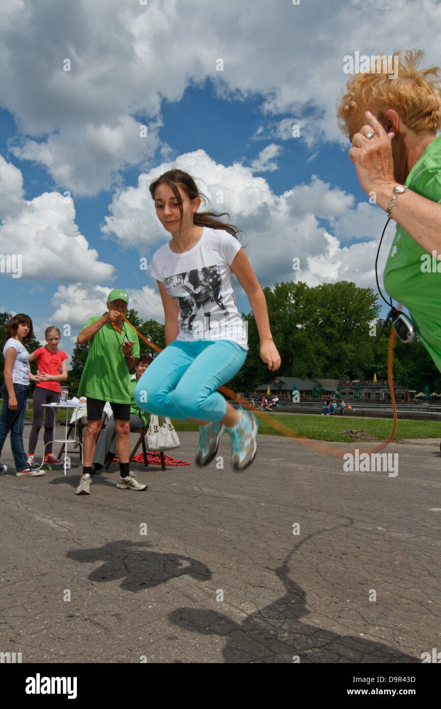 Girl jumping over a skipping rope Stock Photo - Alamy