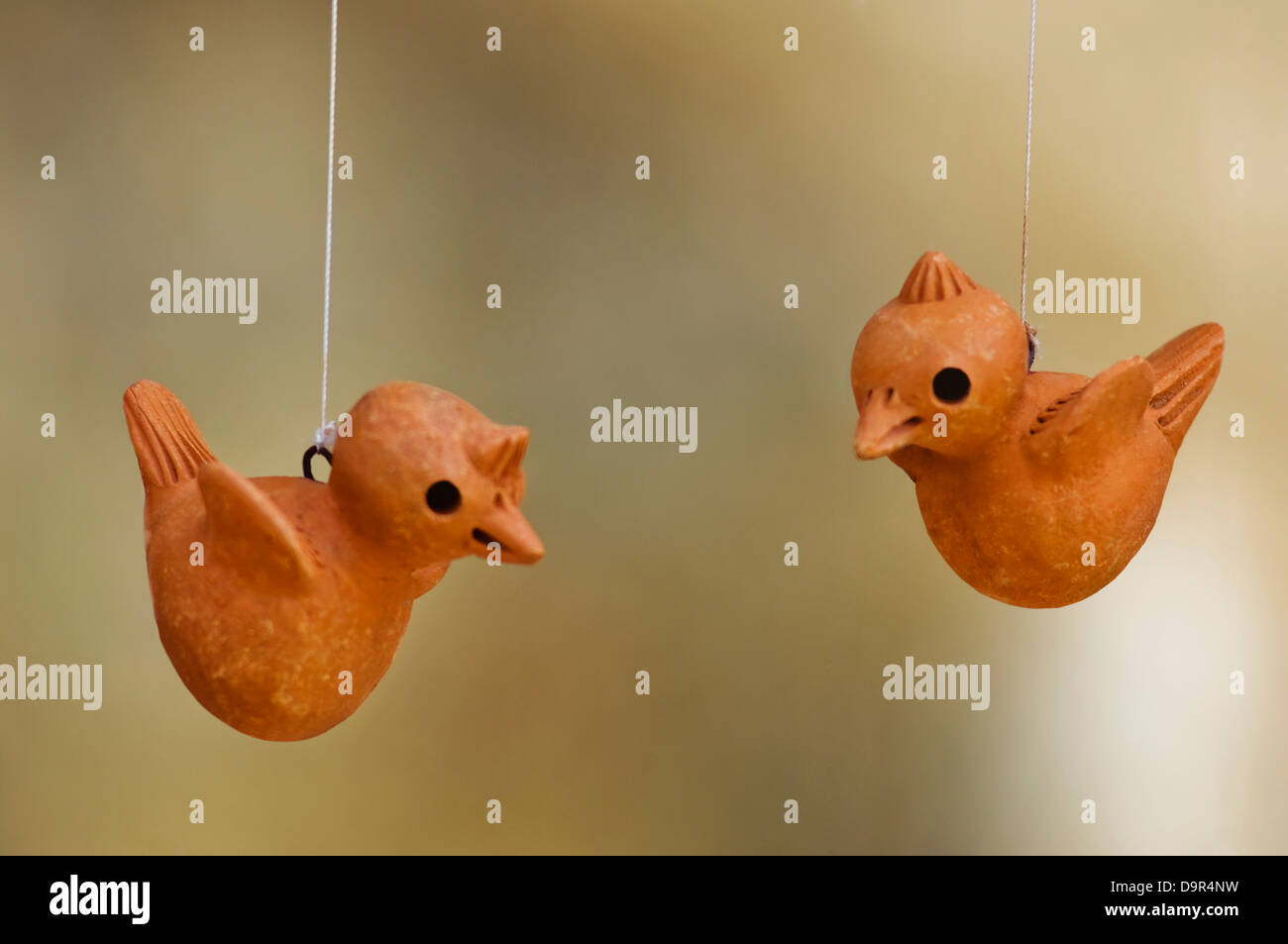 Close-up of wooden little birds hanging by threads Stock Photo - Alamy