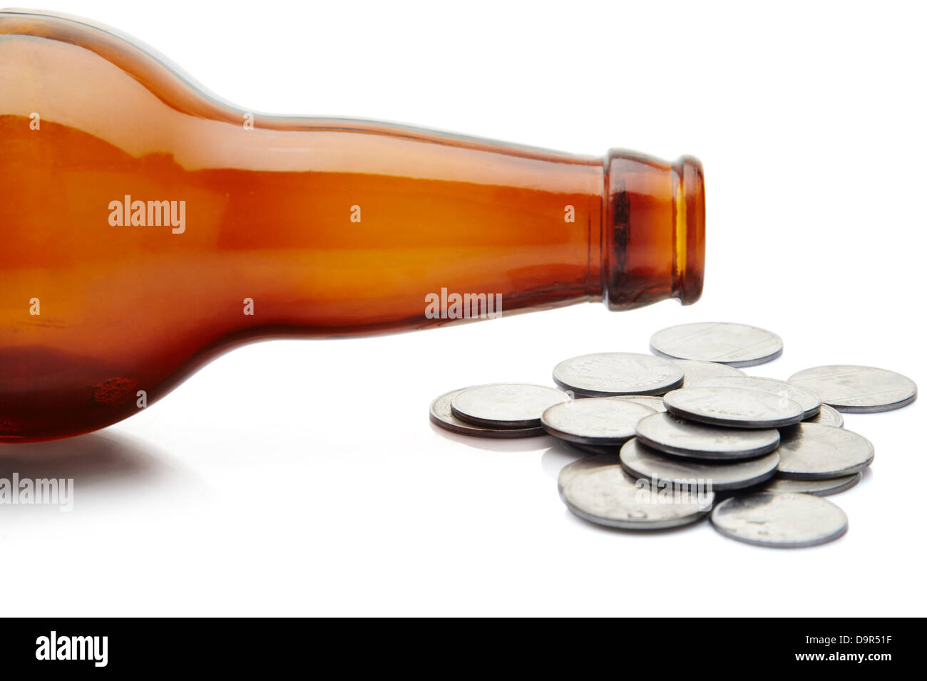 Coins being poured from a beer bottle Stock Photo - Alamy