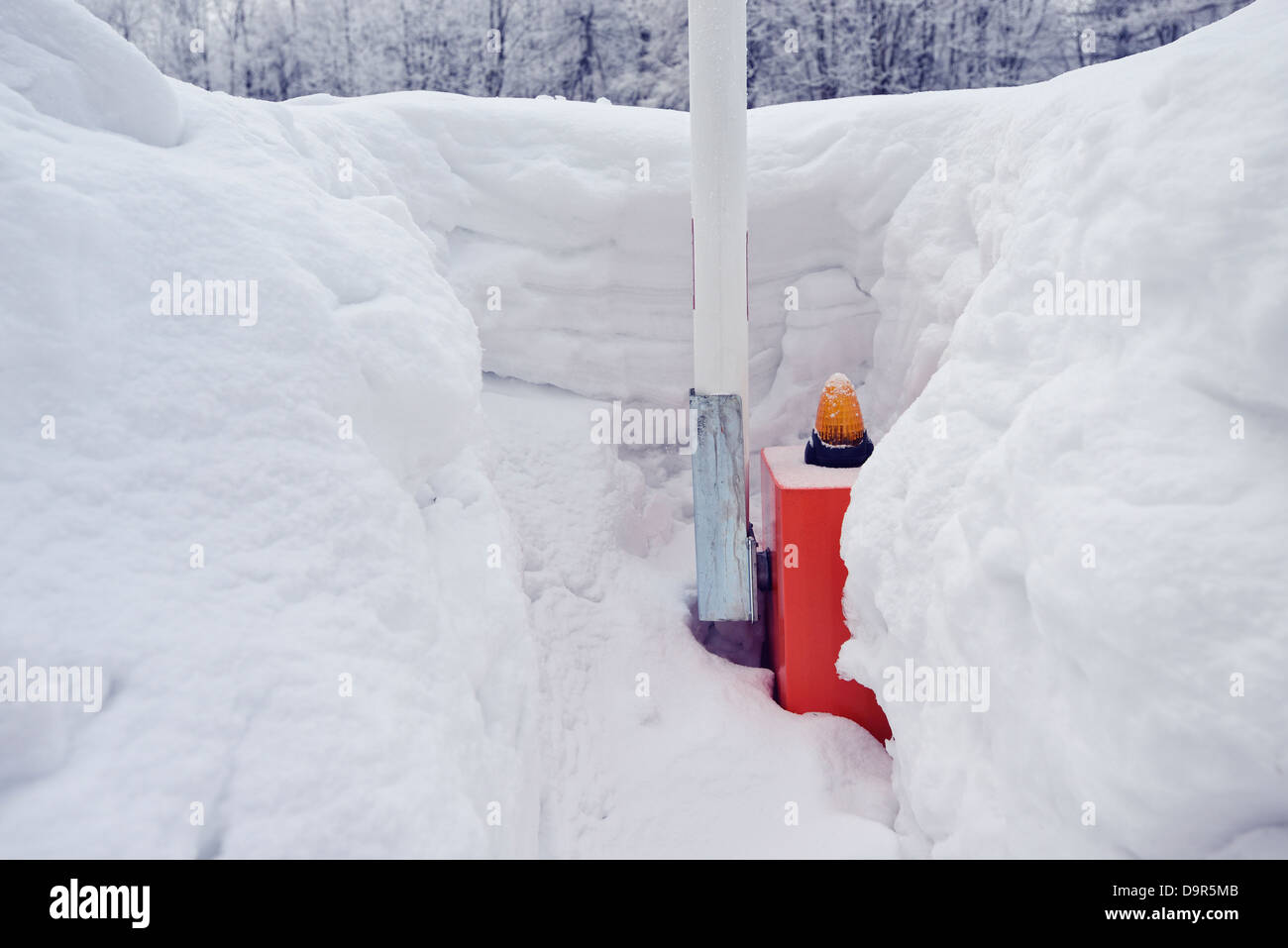 Security barrier with a little beacon alarm system snowcapped in a ...