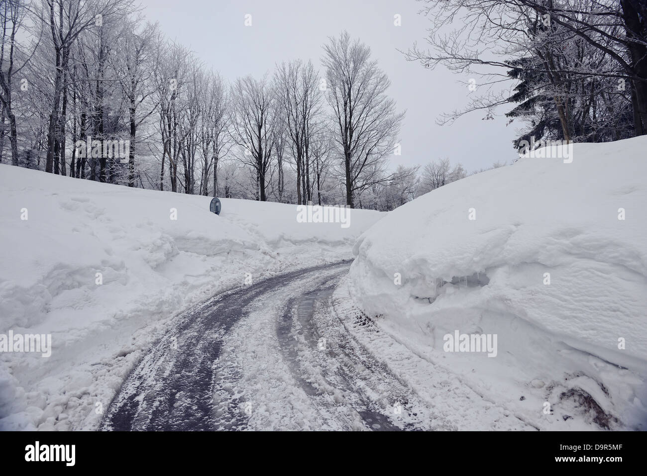 Winter road covered with snowdrifts by its sides Stock Photo - Alamy