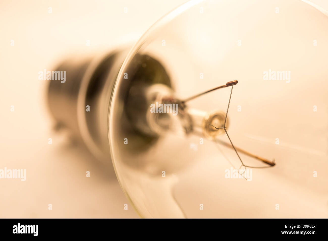 Clear light bulb on white surface Stock Photo - Alamy