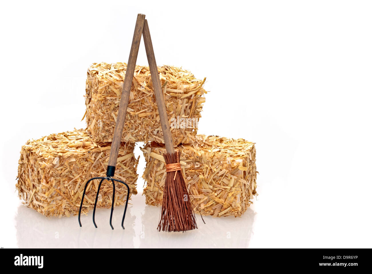 Hay bales with tools on a white background Stock Photo - Alamy