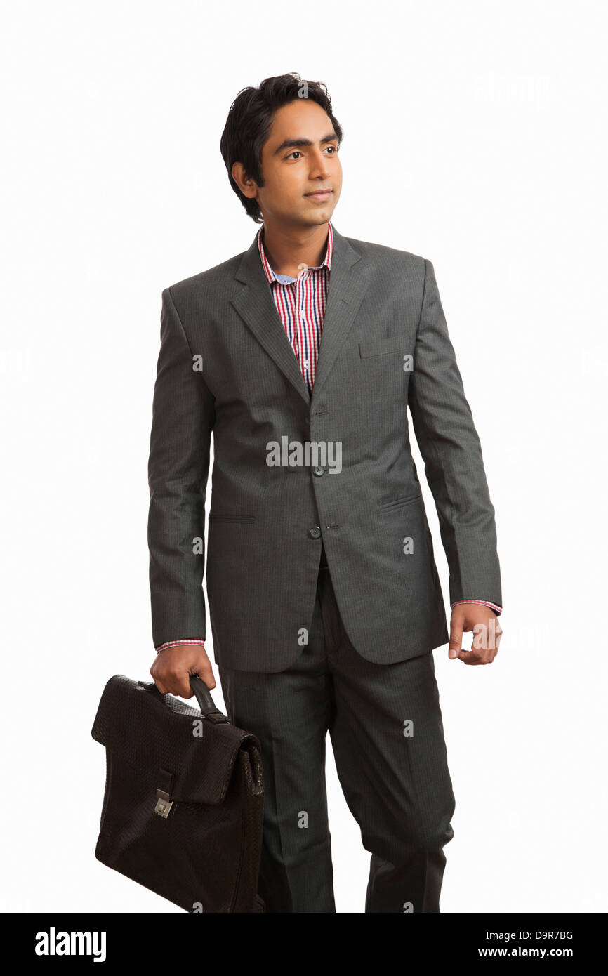 Businessman carrying a briefcase Stock Photo - Alamy
