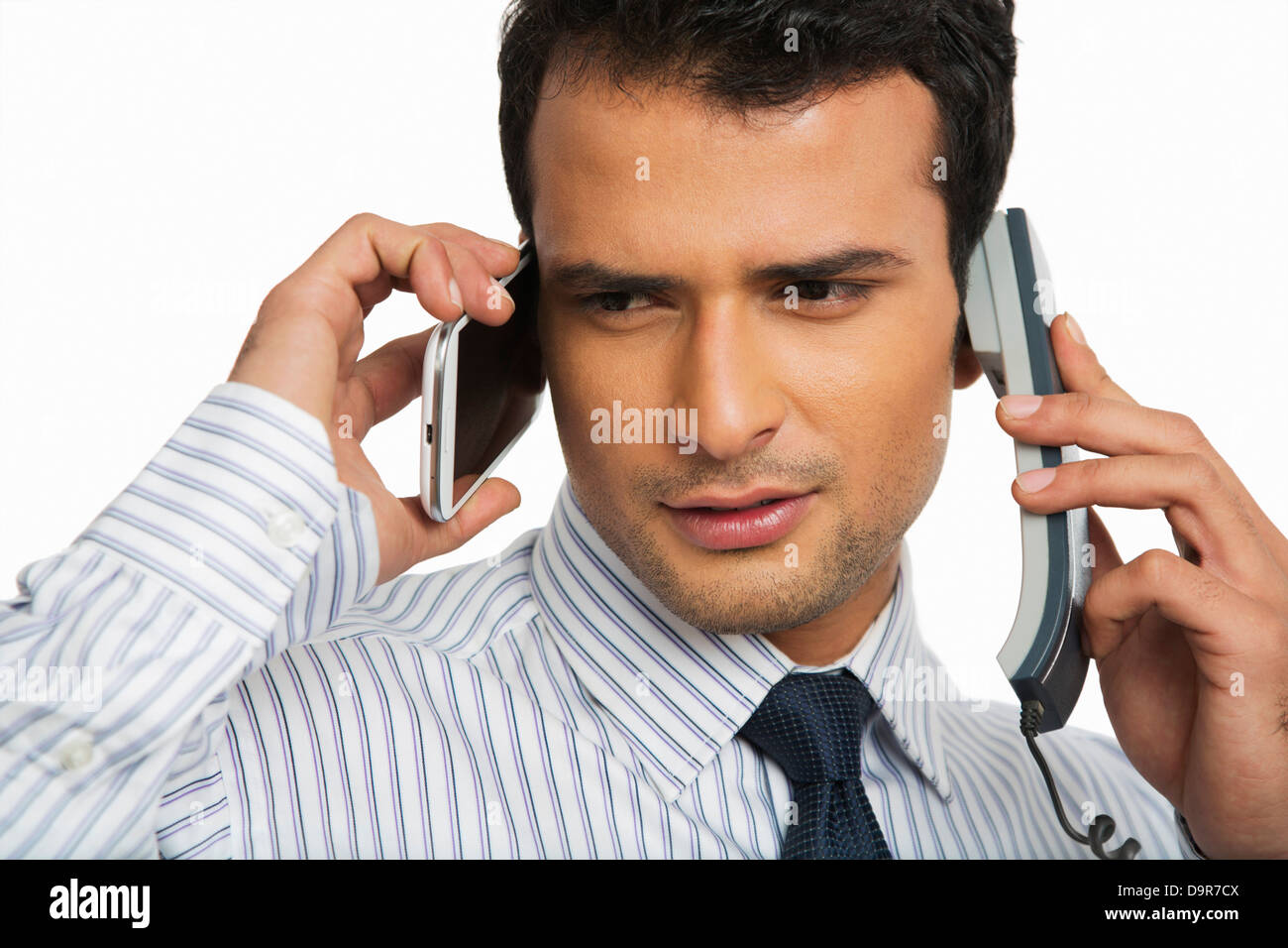 Businessman talking on phones Stock Photo - Alamy