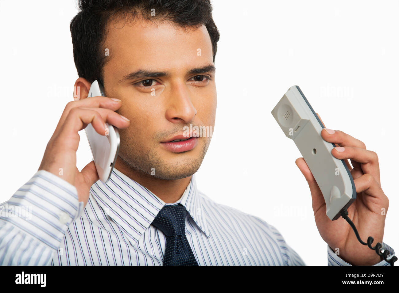 Businessman talking on phones Stock Photo - Alamy