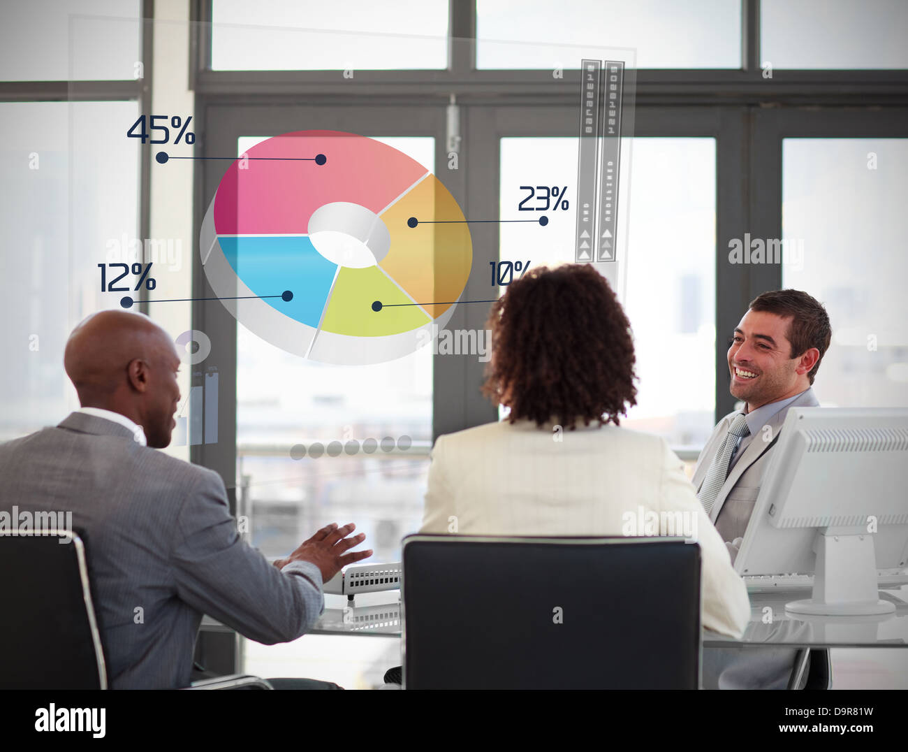 Smiling business people using colorful pie chart on futuristic ...