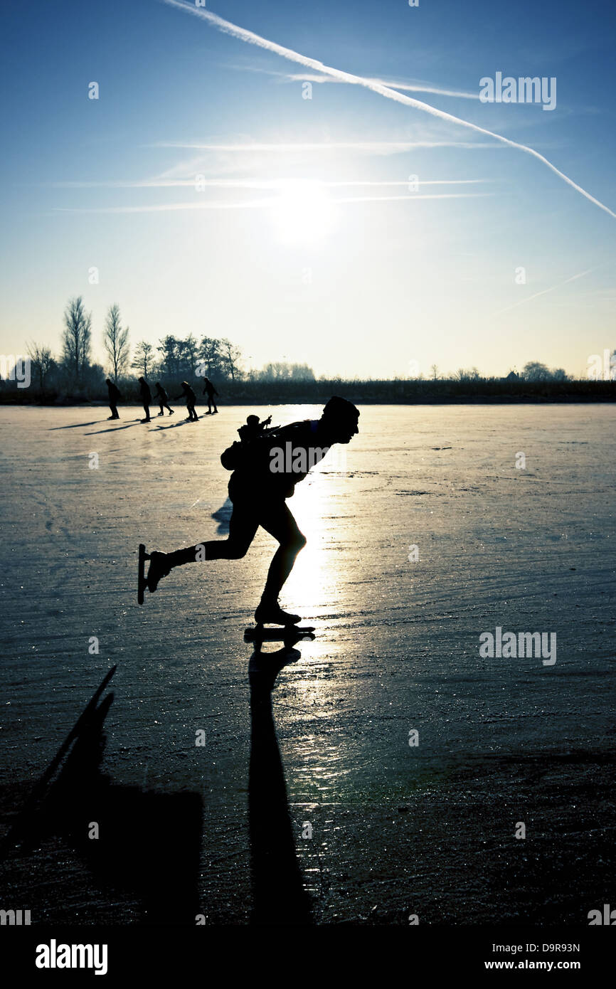 Ice skating at sunset in the Netherlands Stock Photo - Alamy