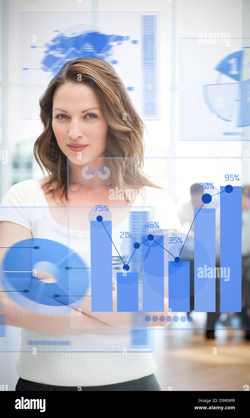 Confident blonde businesswoman using chart interfaces Stock Photo - Alamy