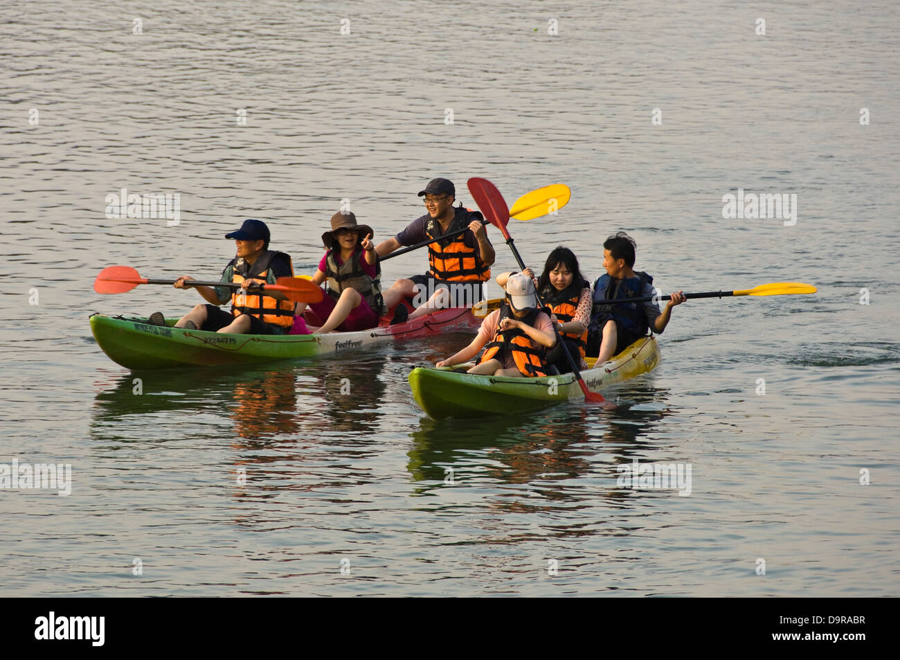 Horizontal view of people kayaking along the Nam Song river in Vang ...