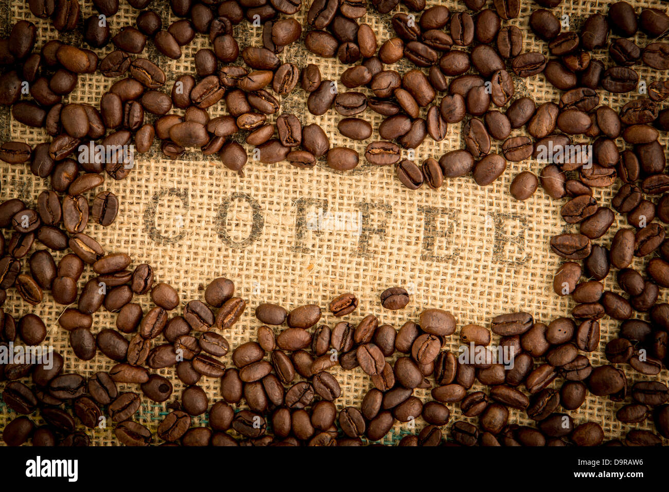 Coffee beans surrounding coffee stamp on sack Stock Photo - Alamy
