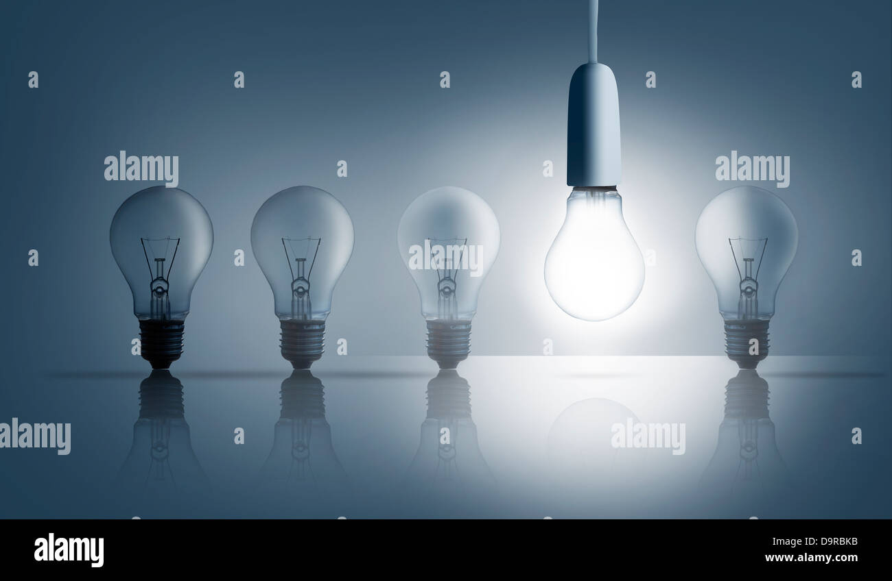 Five light bulbs in a row with one lit up Stock Photo - Alamy
