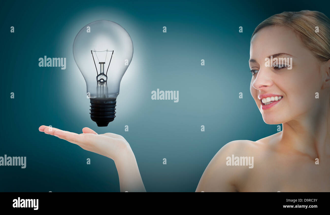 Big light bulb lighting inside hand Stock Photo - Alamy