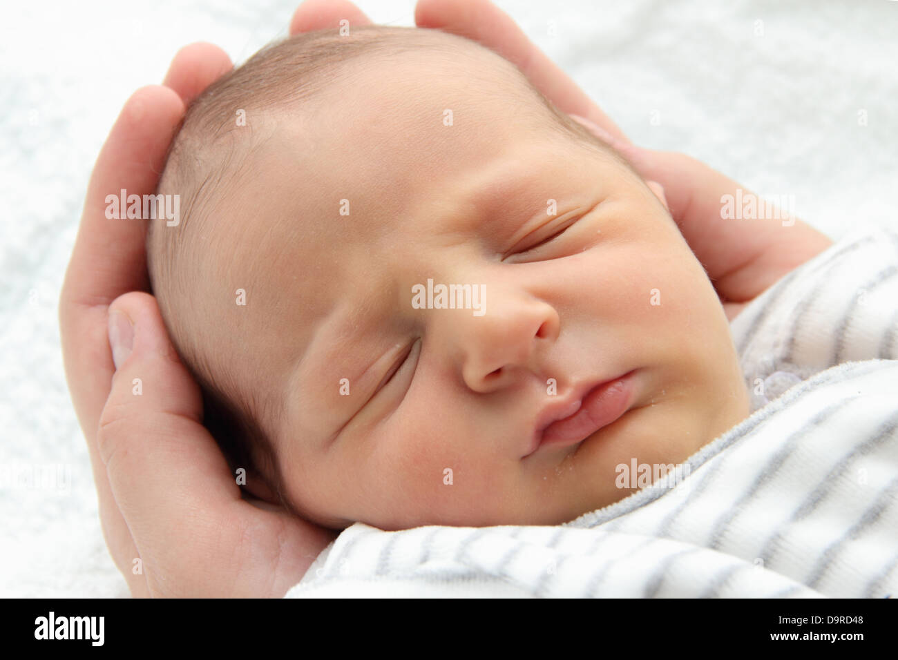 A beautiful sleeping baby in hands Stock Photo - Alamy