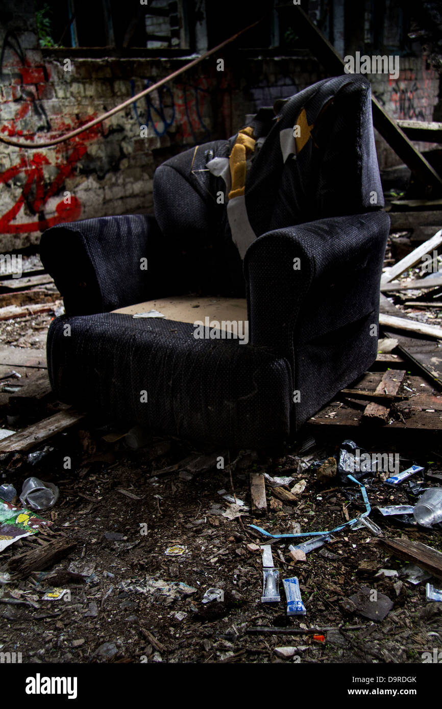 Crack den, an old armchair sits in the middle of a collapsing building ...