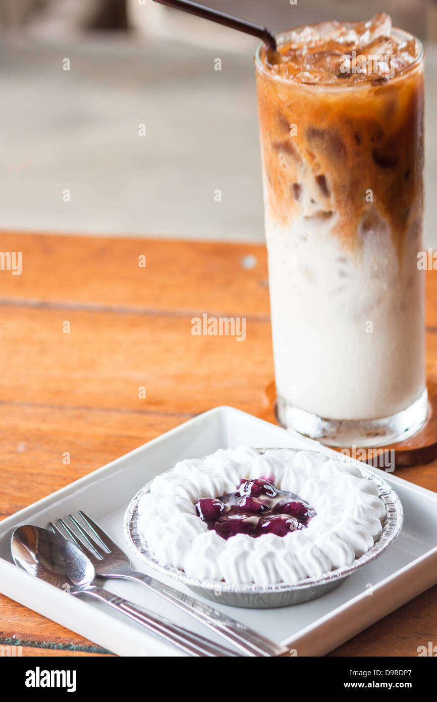 Blueberries cheese cupcake and cold coffee latte Stock Photo - Alamy