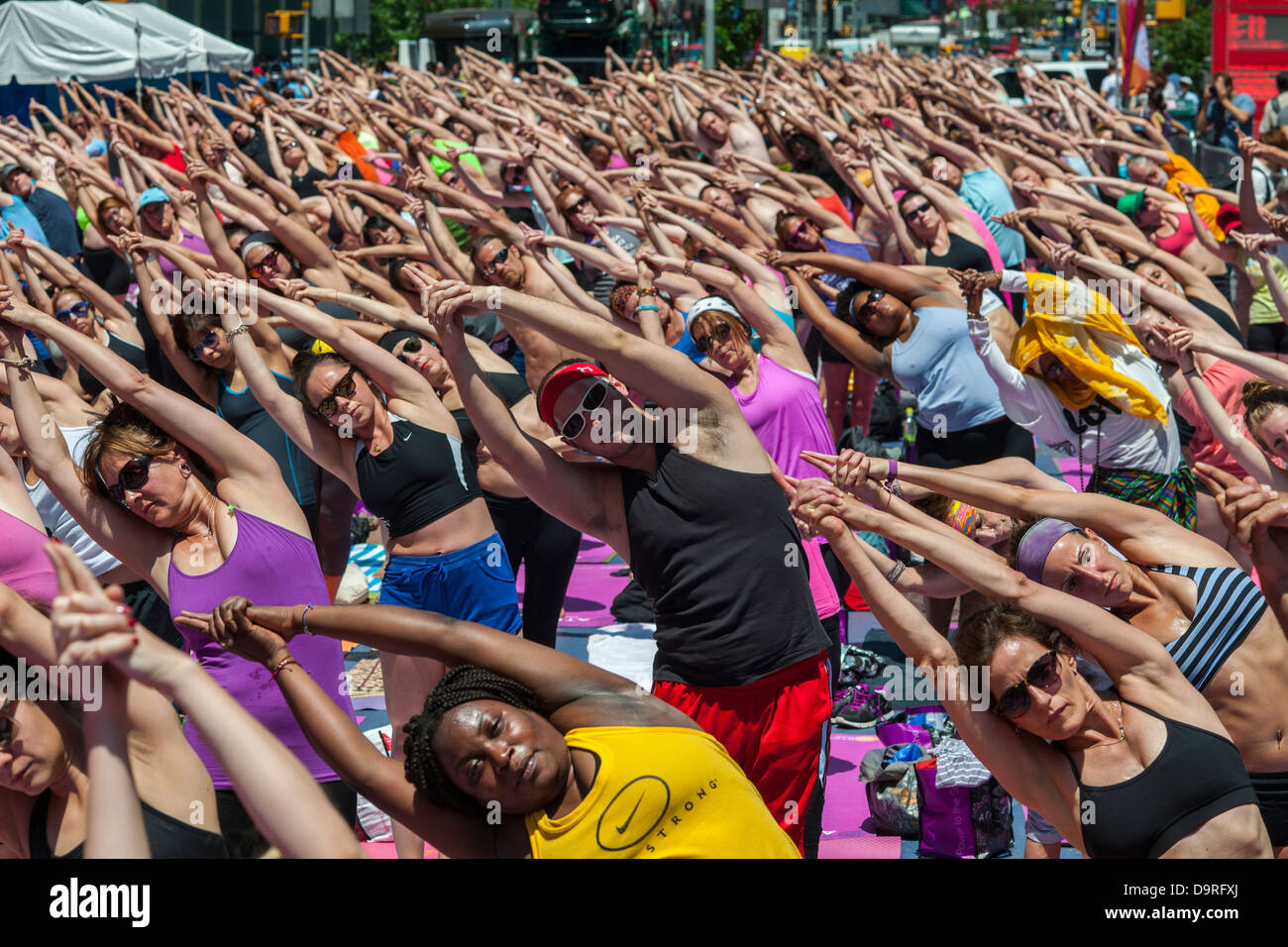 Yoga practitioners pack Times Square in New York to participate in a ...