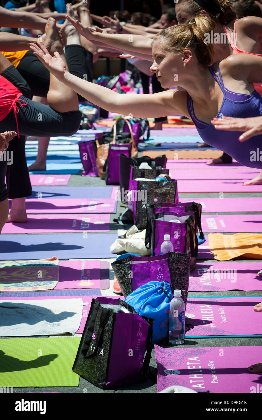 Yoga practitioners pack Times Square in New York to participate in a ...