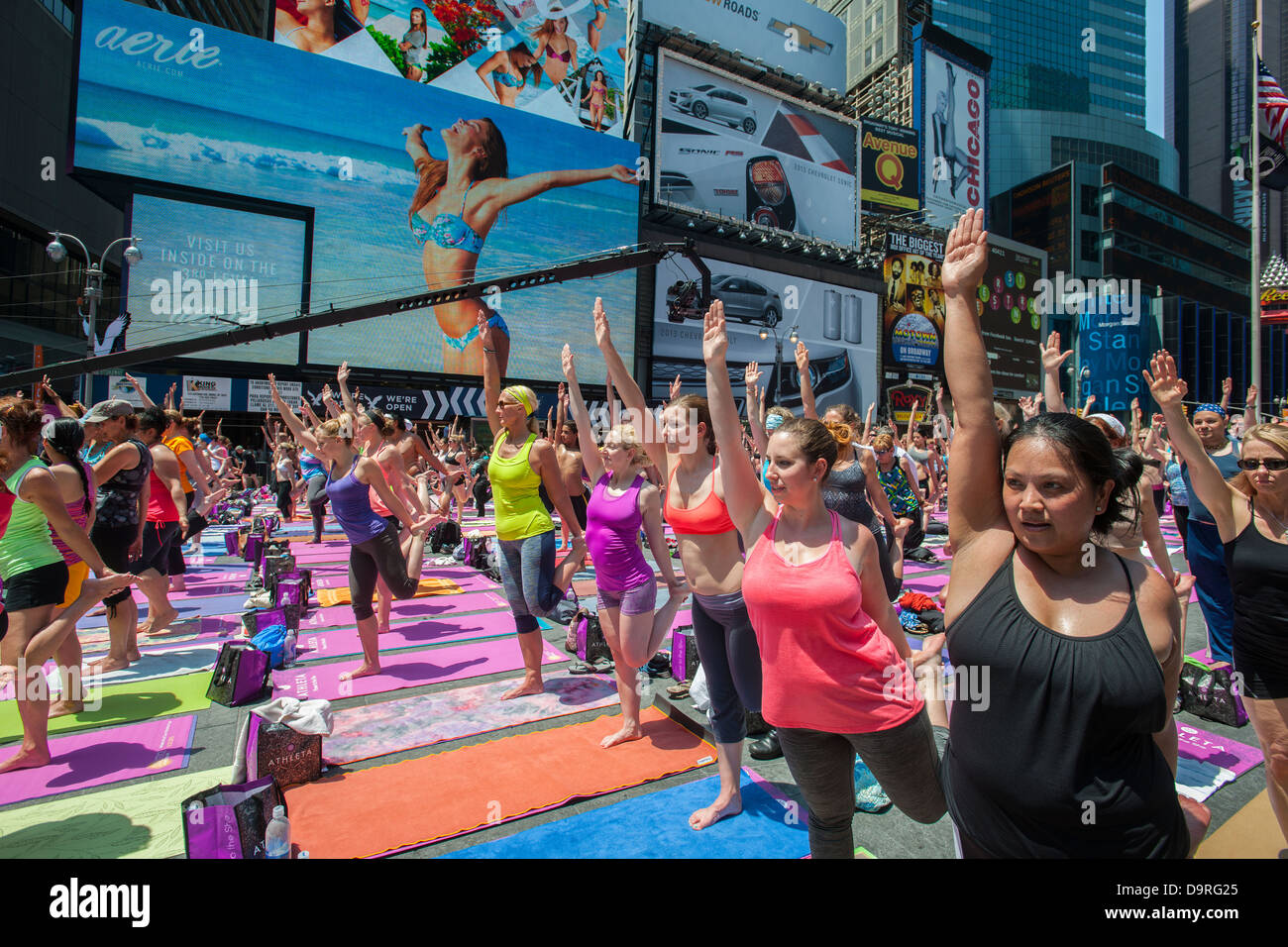 Yoga practitioners pack Times Square in New York to participate in a ...